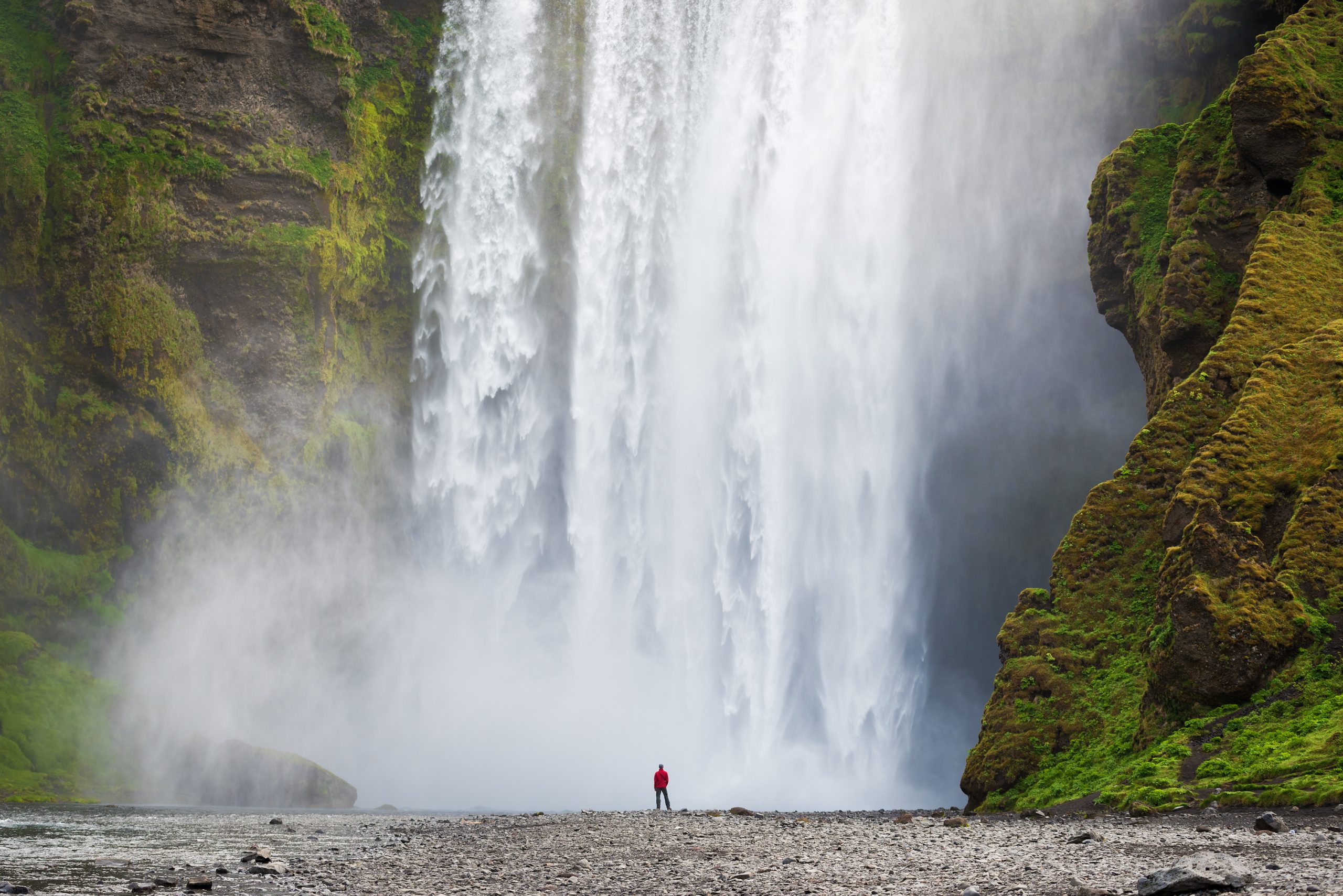 Tourist near Skogafoss waterfall in Iceland | Ruah Woods Institute
